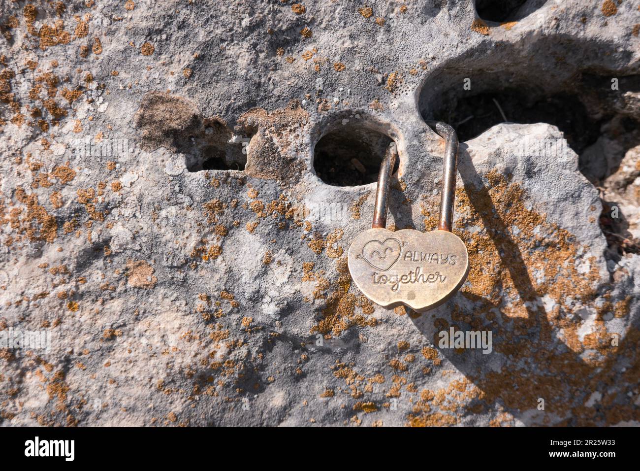Small lock as symbol of eternal love hangs locked on rock. Details of ...