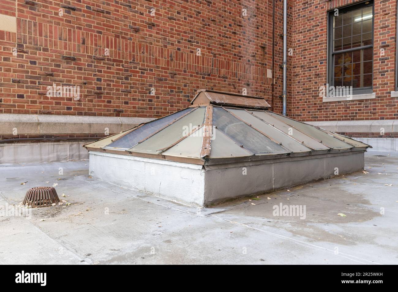 Old, vintage metal framed double pitched skylight on a flat commercial ...