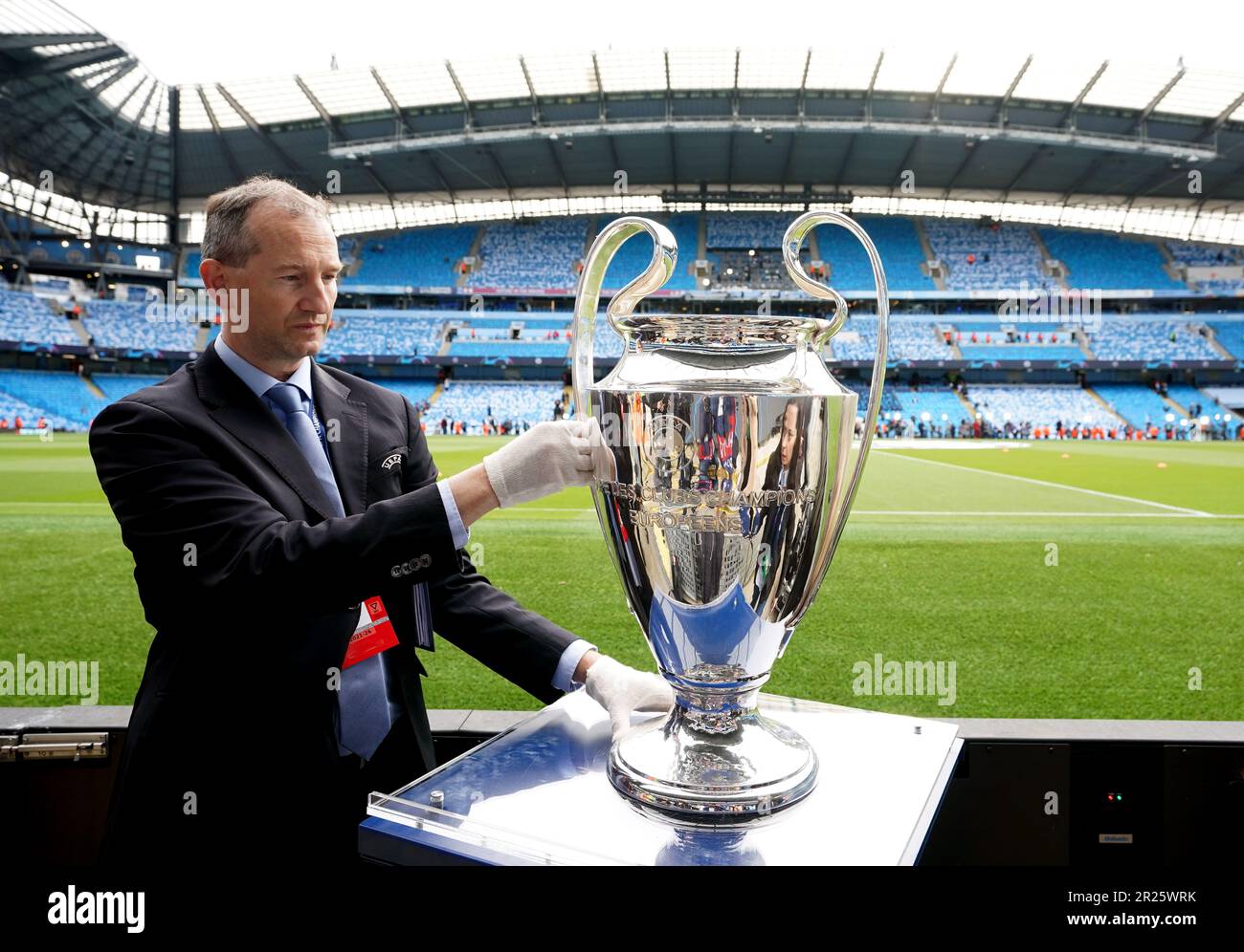 A UEFA official places the UEFA Champions League Trophy on its stand ...