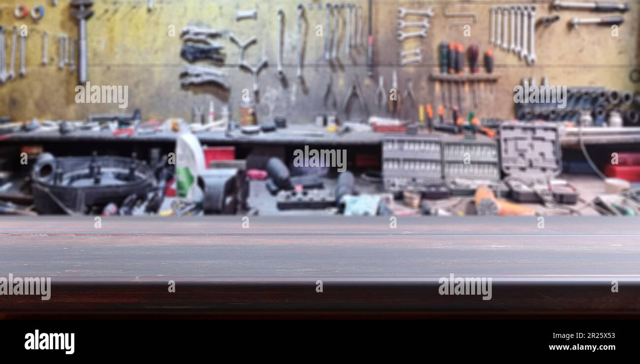 Empty wooden table, blur workshop and garage tools background. Template ...