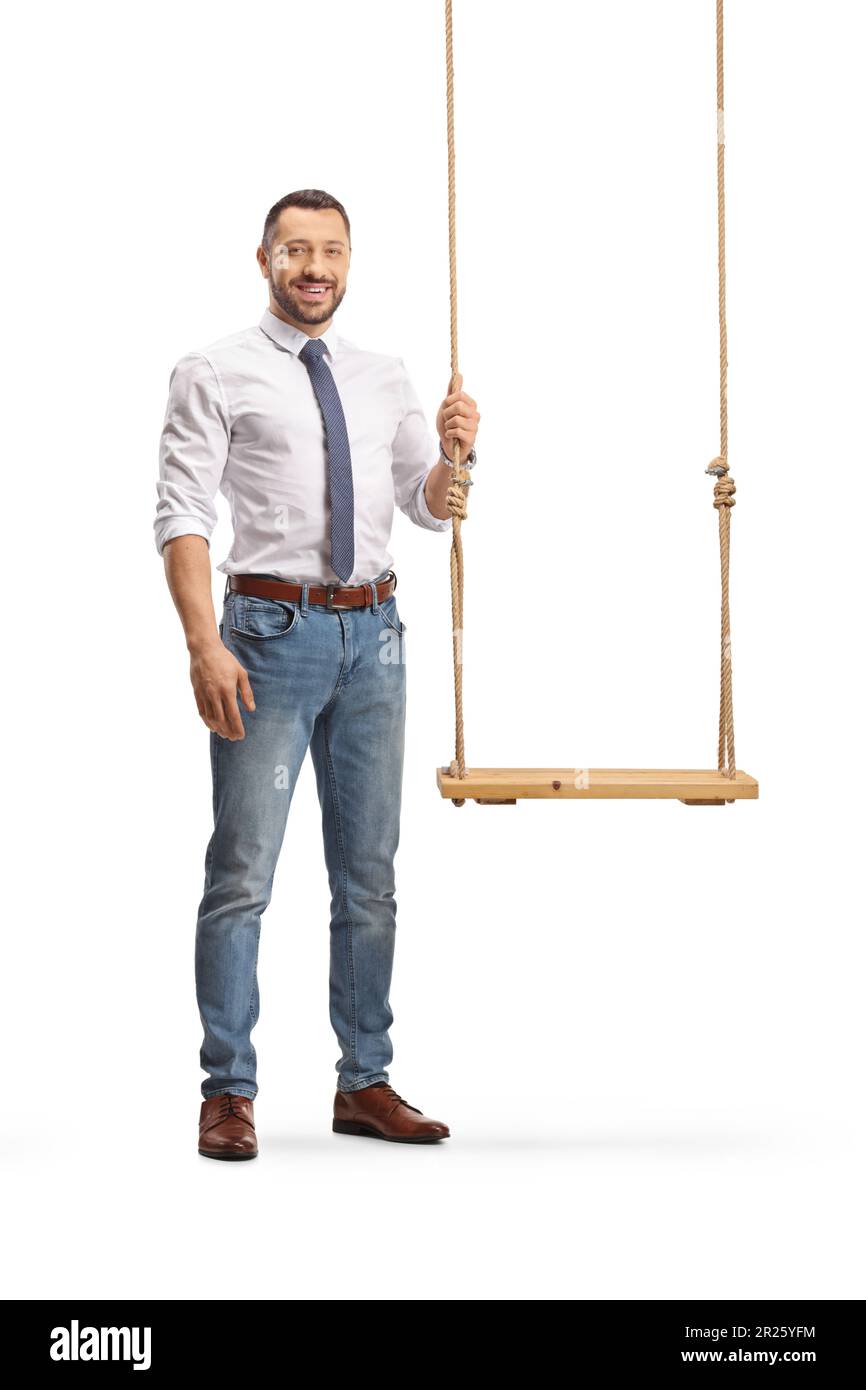 Full length portrait of a man standing next to an empty wooden swing ...