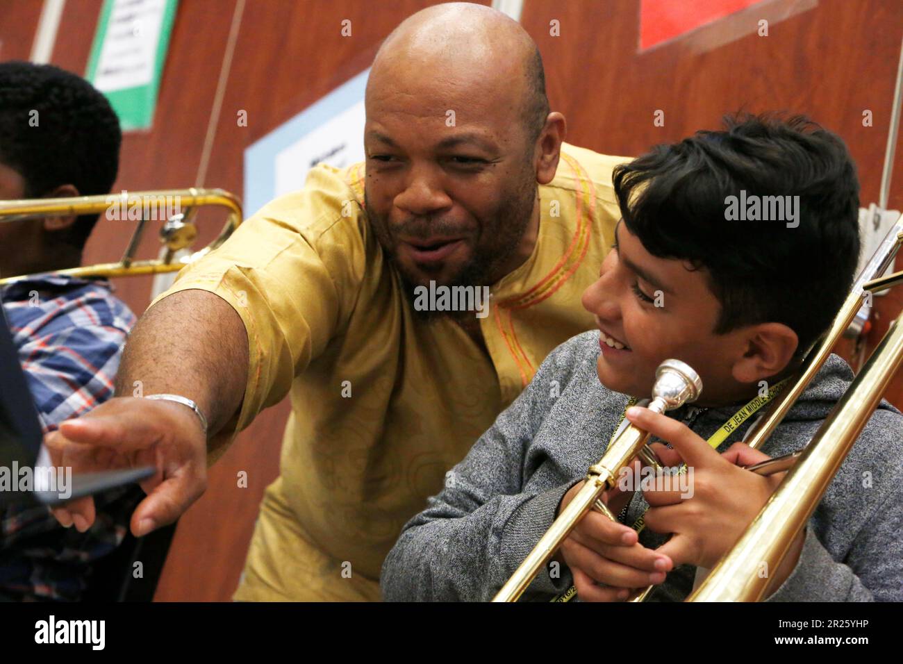Darrell Perry works with Steve Lopez during advanced band class at Lovonya DeJean Middle School ...