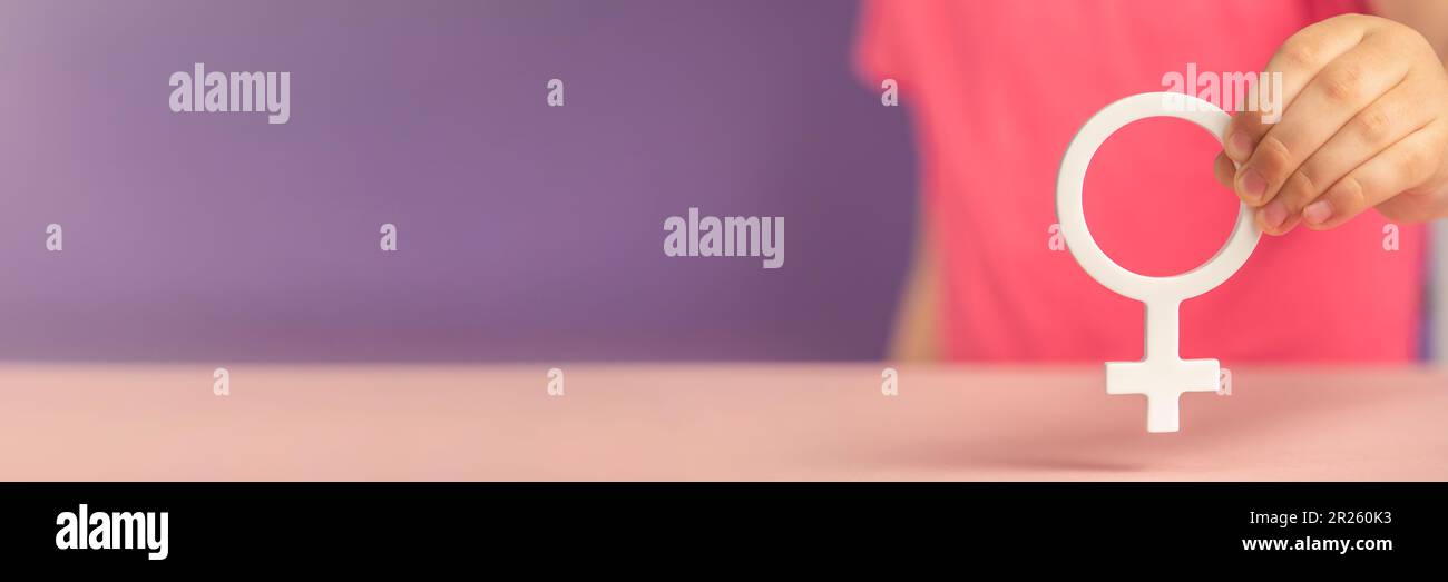 Gender symbol of a woman. Banner with woman symbol in hands on purple ...