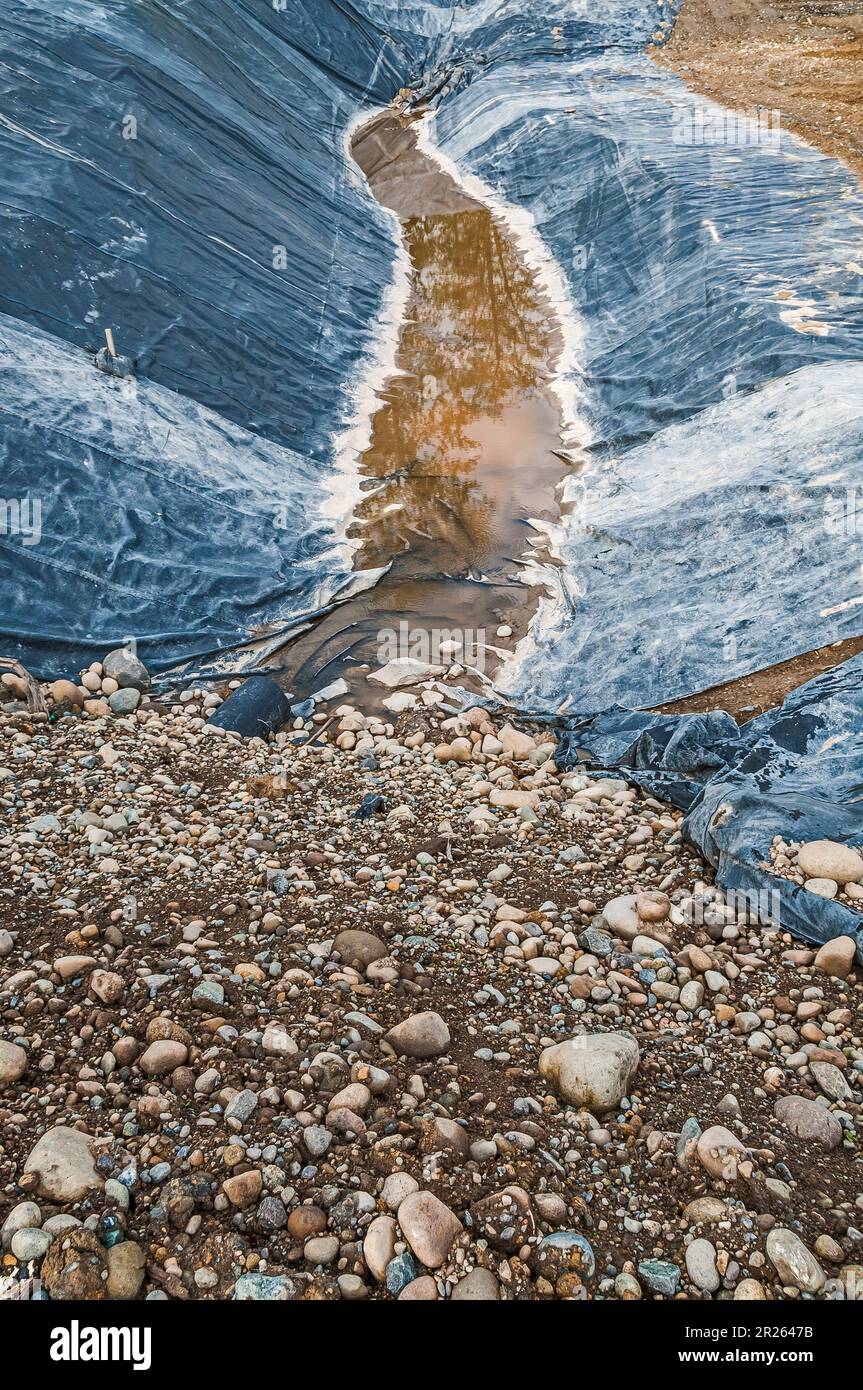 Water pools in a depression in a geomembrane at an active landfill ...