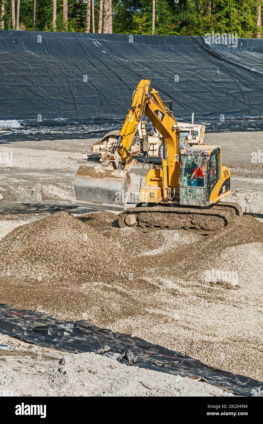 A power shovel works on an excavation at an active landfill Stock Photo ...