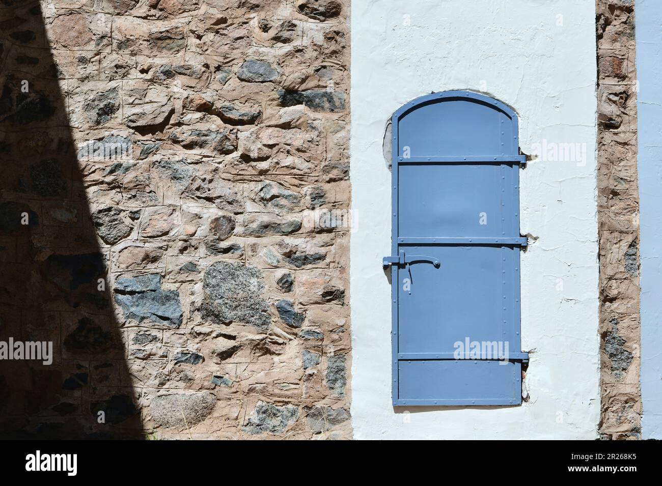 Abstract building doorway with multi-colored stone and light grout with ...