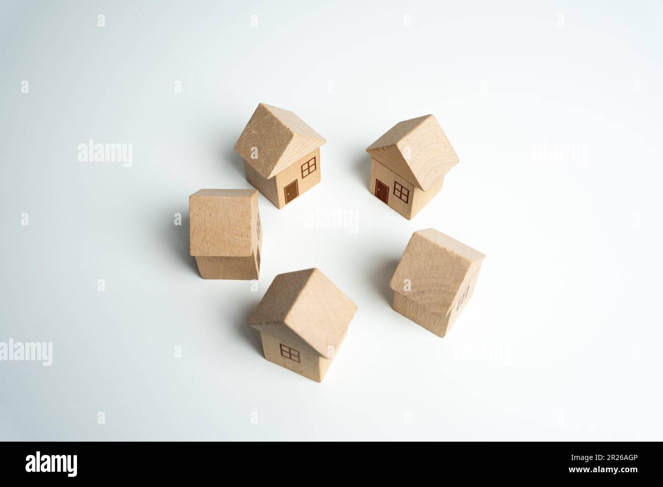 Wooden toy houses stand in a circle. Community of homeowners. Build ...