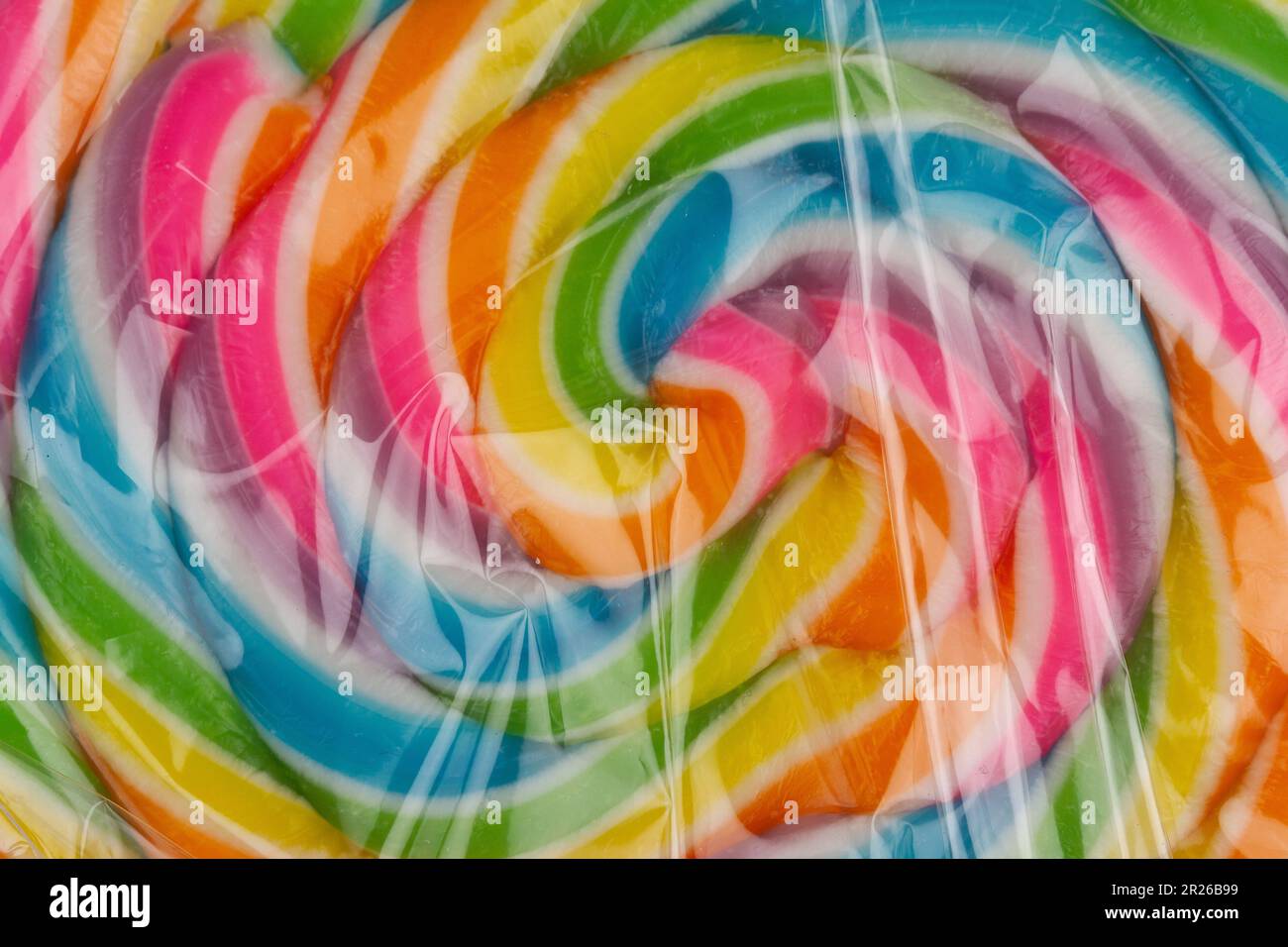 closeup detail of colorful lollipop candy on a stick in transparent ...