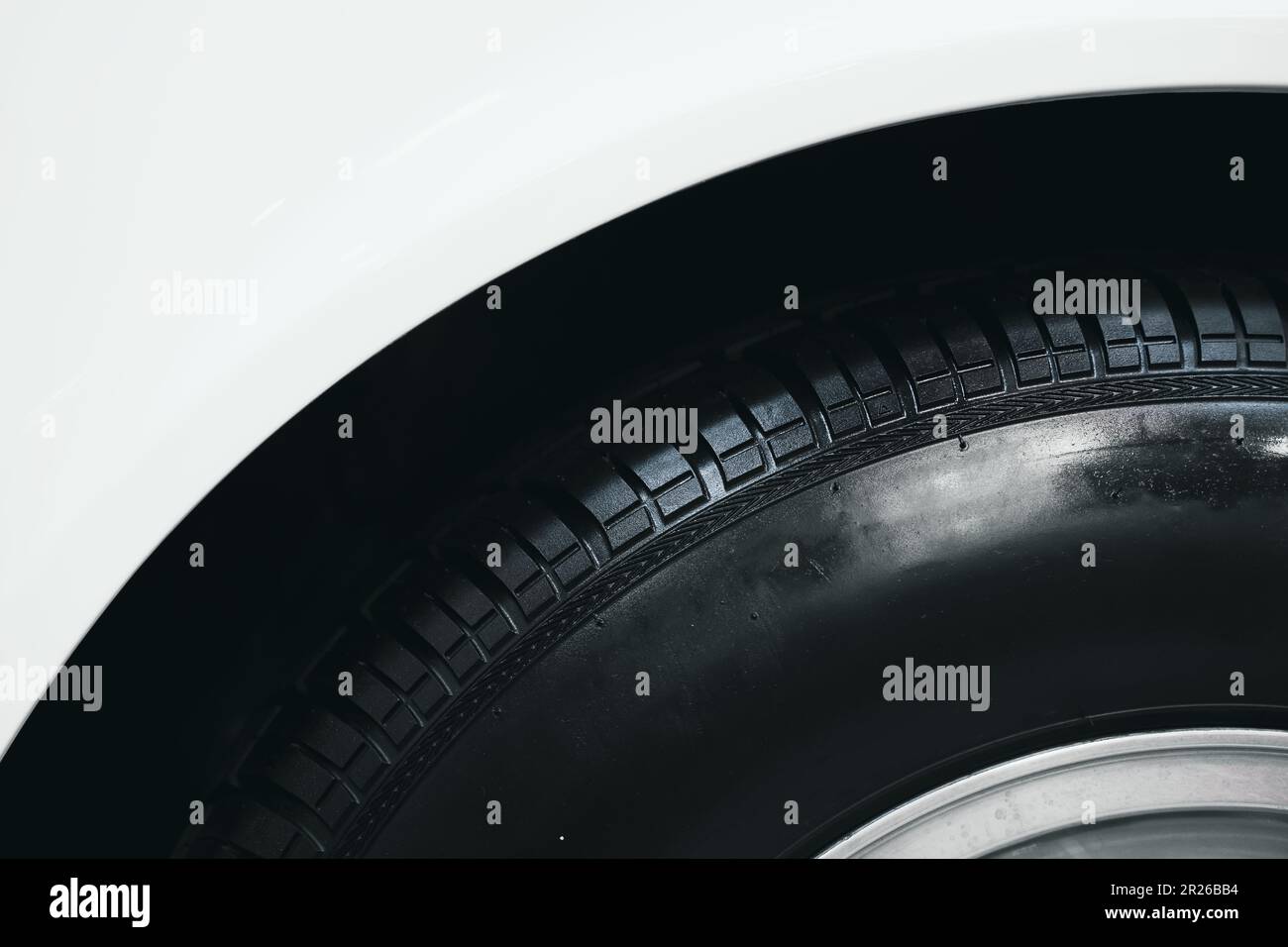 front view detail of car wheel black rubber tire on the front wing ...