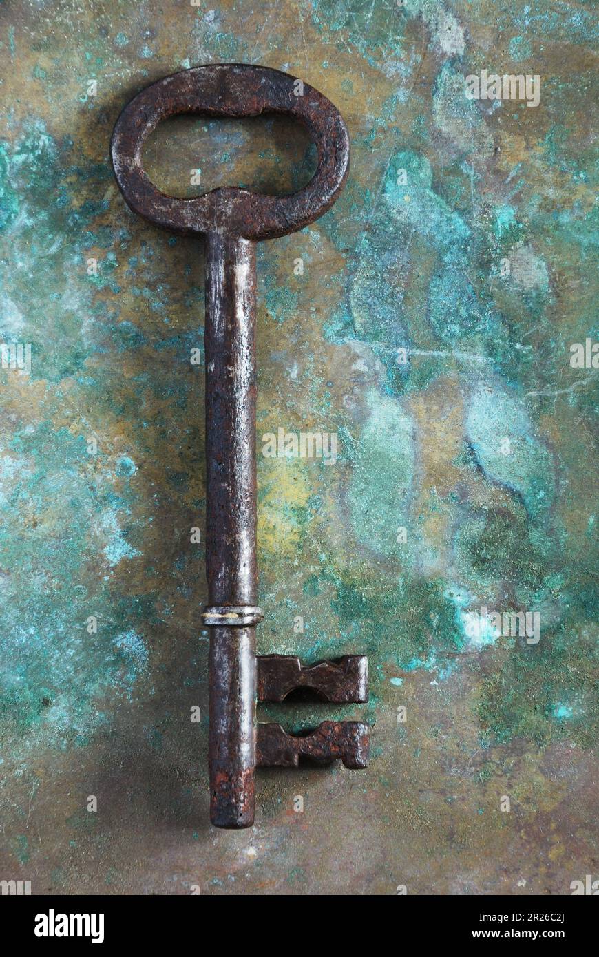 old rusty big key key on patina covered copper surface Stock Photo - Alamy