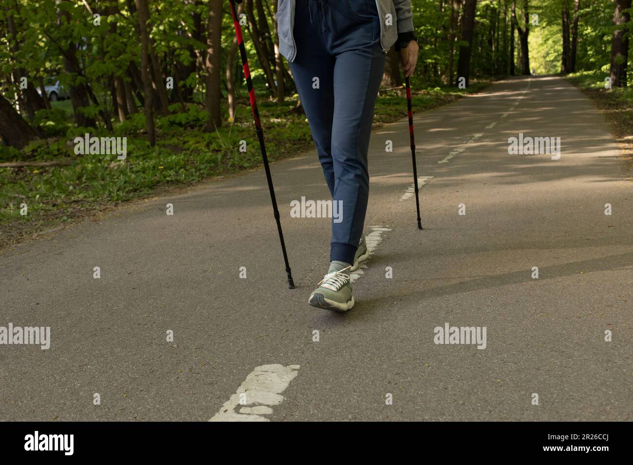Woman's Legs Trekking With Sticks, Step Along The Path In Park, Cropped ...