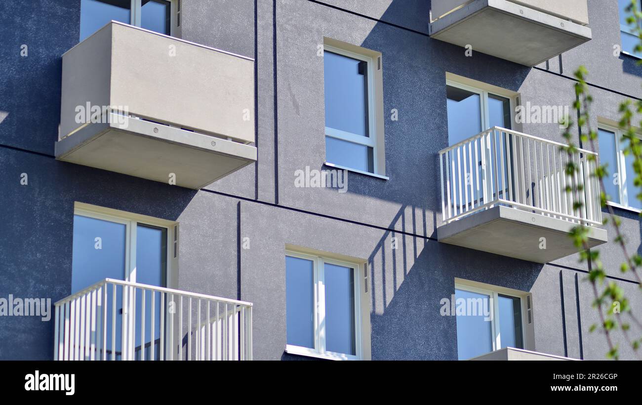 Apartment building with bright facades. Modern minimalist architecture with lots of square glass ...
