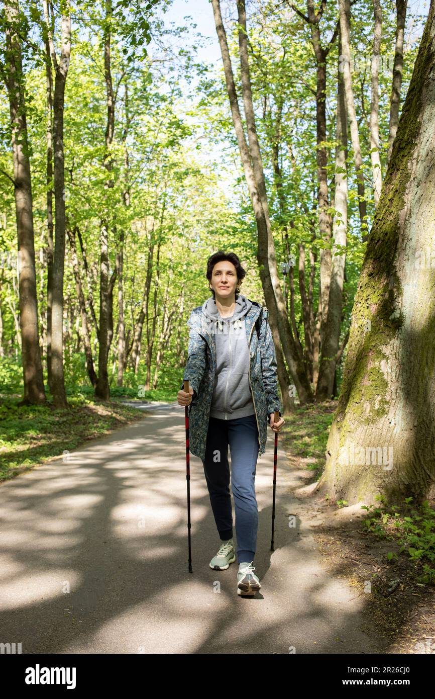 People walking scandinavian trekking sticks hi-res stock photography ...