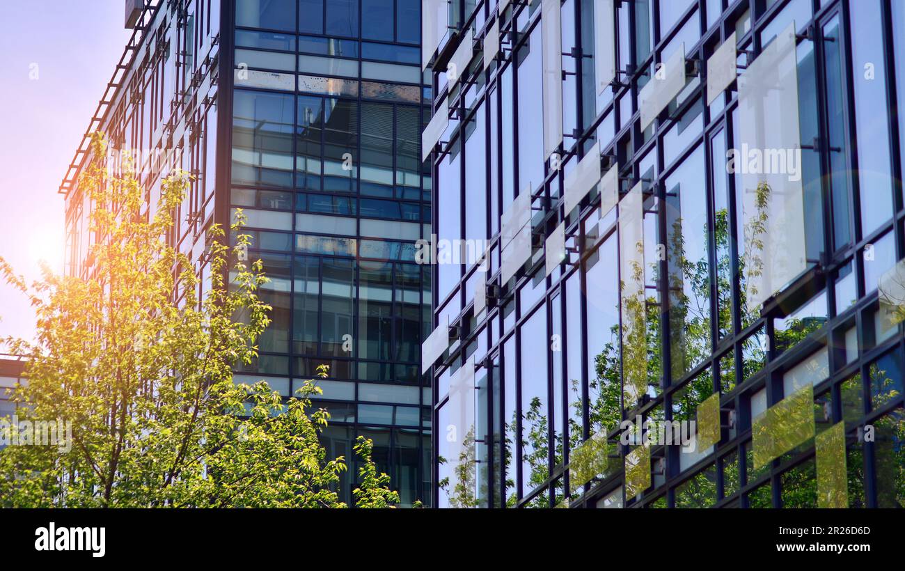 Reflection of modern commercial building on glass with sunlight. Eco ...