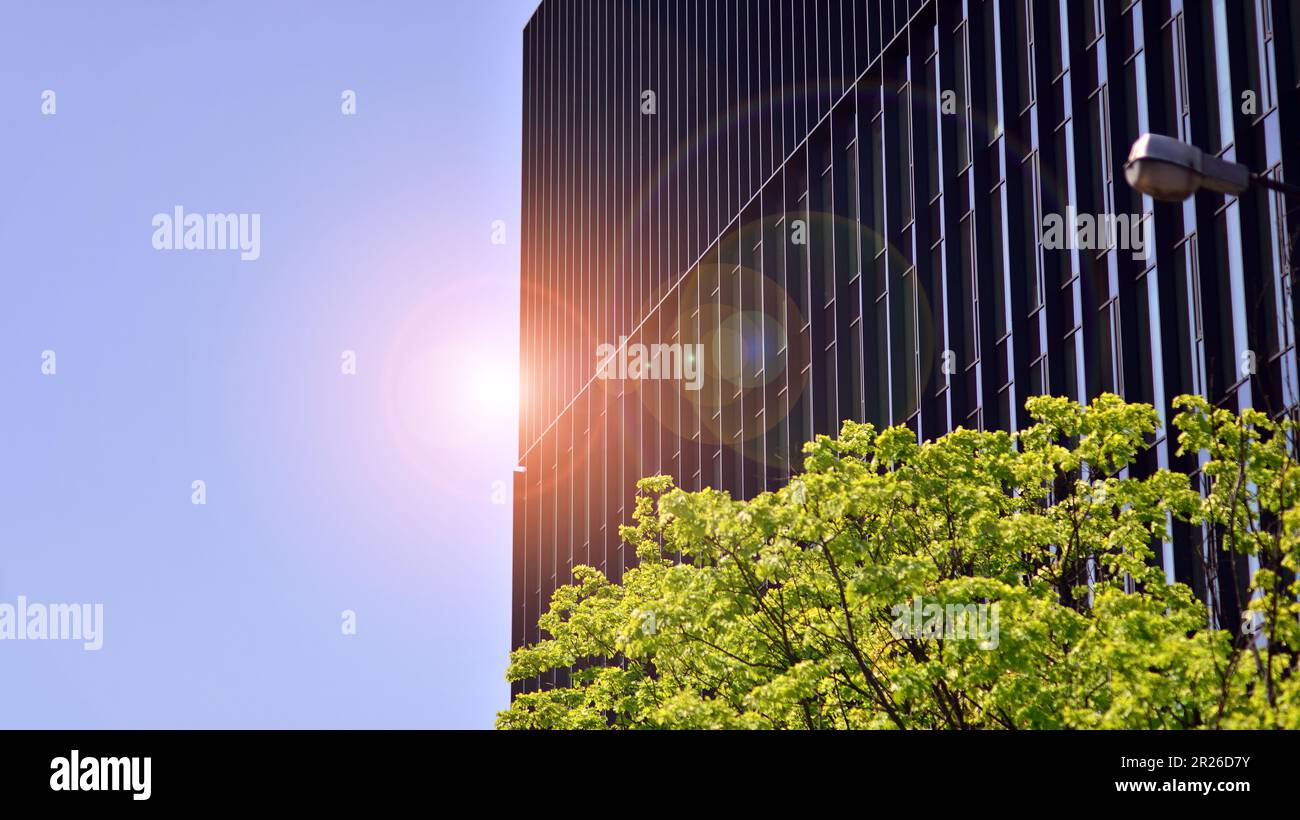 Reflection of modern commercial building on glass with sunlight. Eco ...