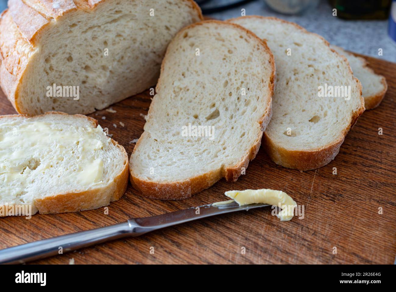 Sliced bread on a wooden chopping board, battered sandwich, morning ...