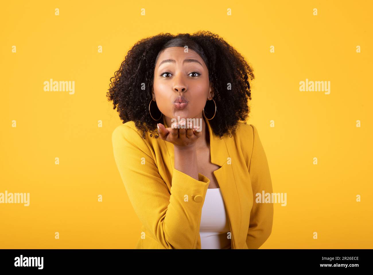 Pretty flirting black lady blowing air kiss posing at camera over ...