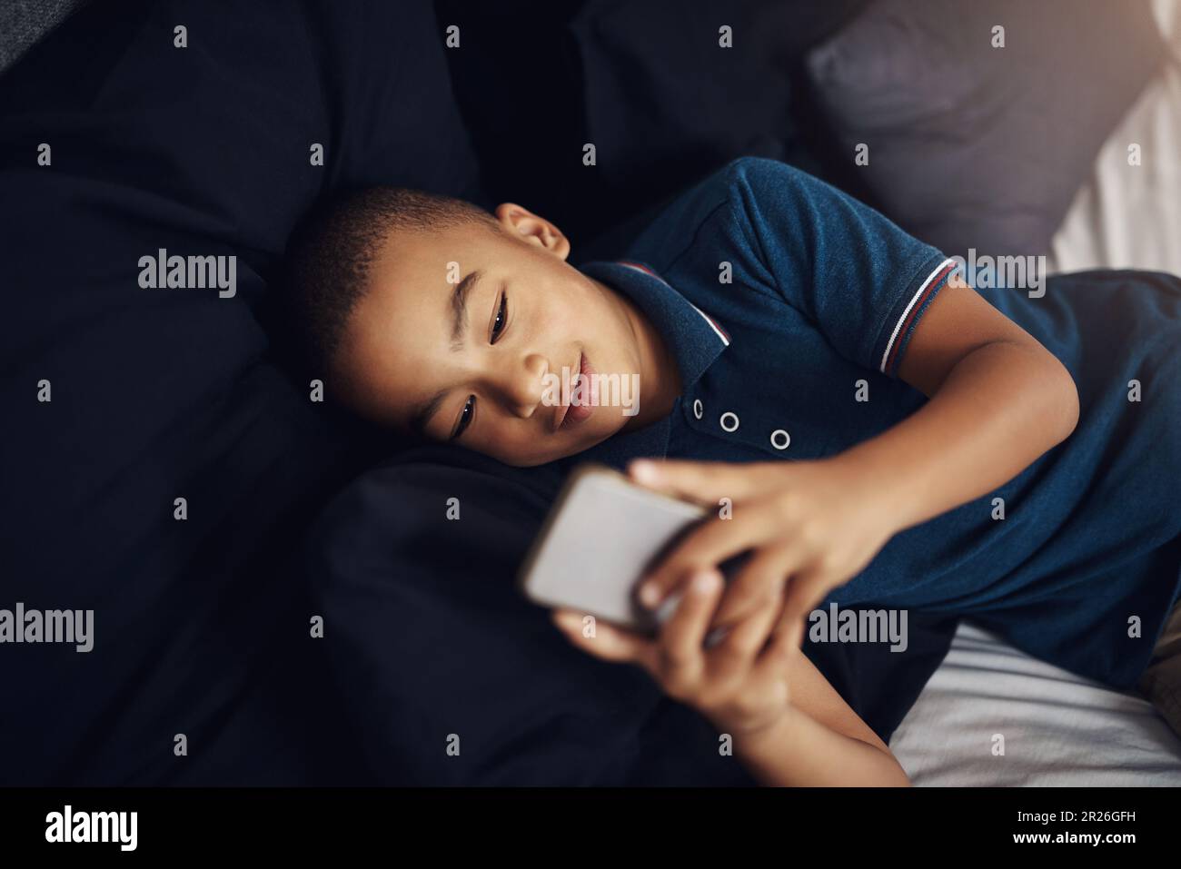 its up to you to monitor your childs smartphone use. a young boy using ...