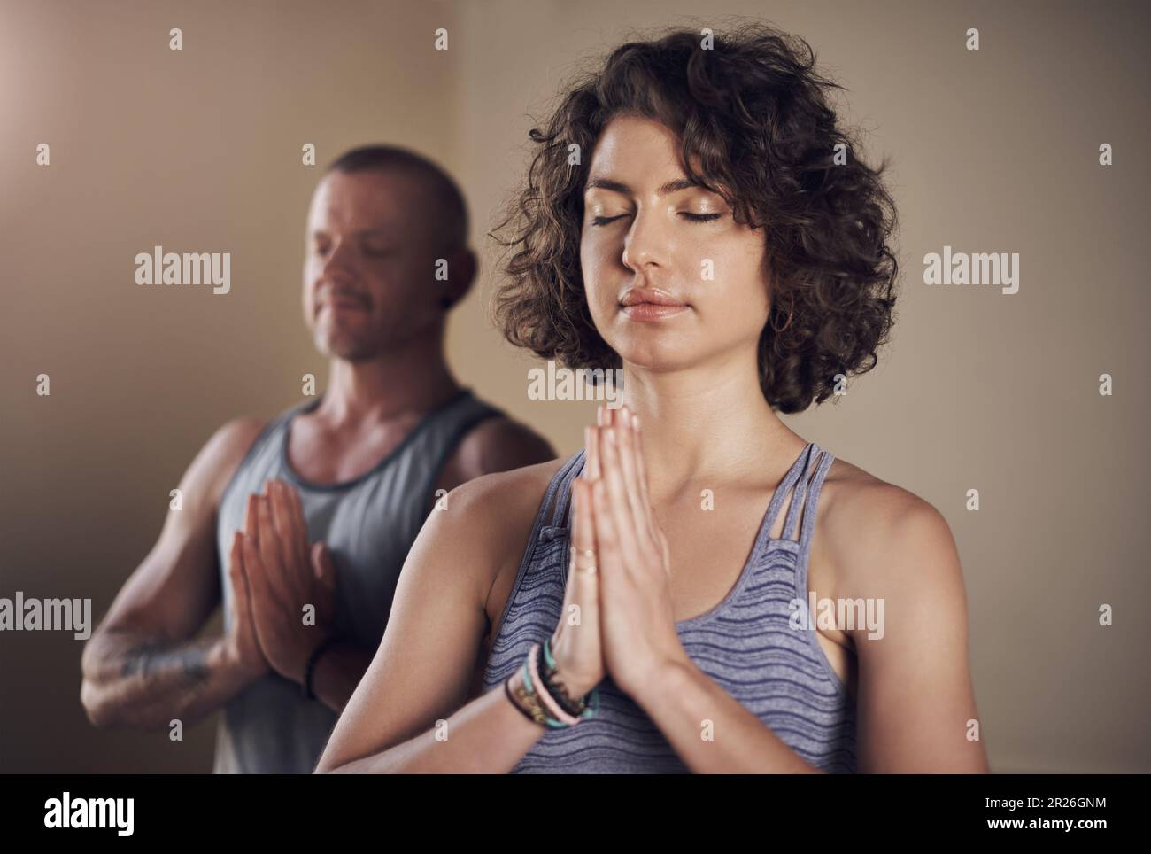 Connecting to our inner beings. two young yogis standing together and ...