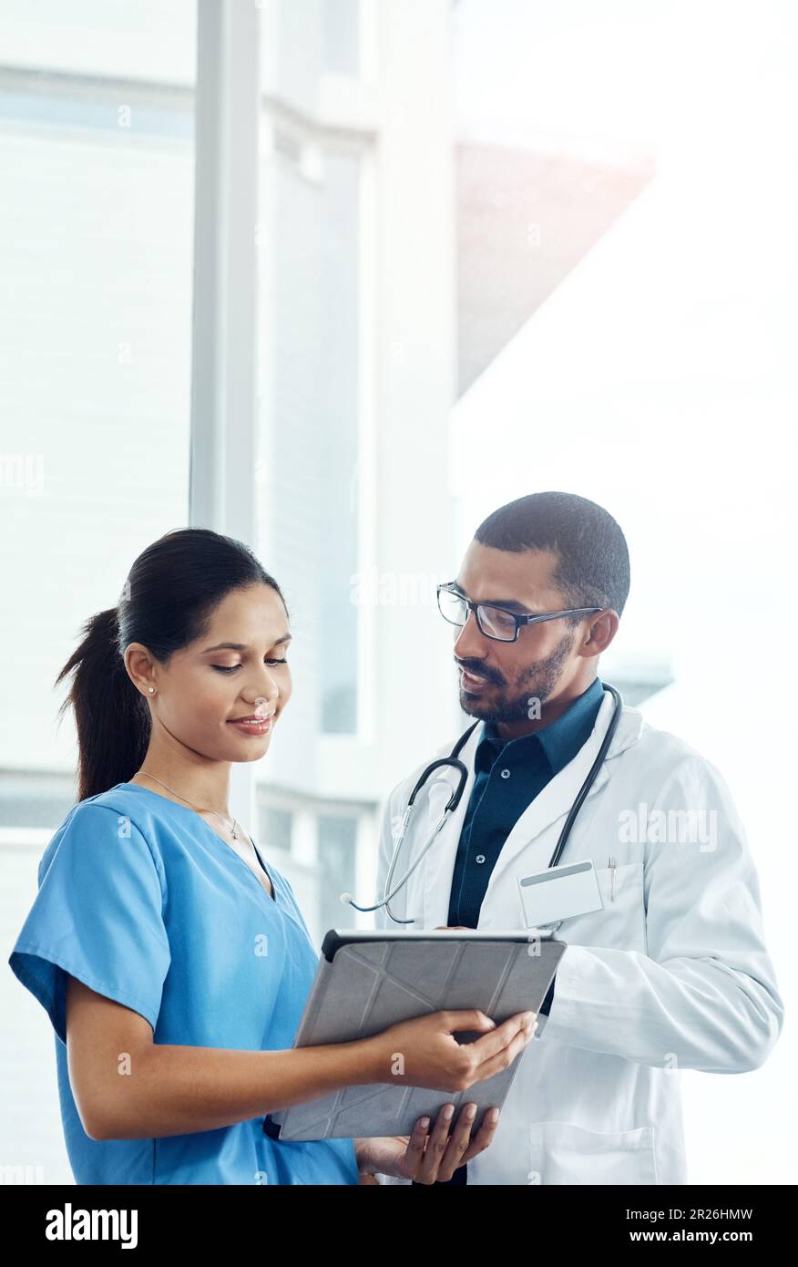 Technology will simplify the diagnosis process. two young doctors using ...