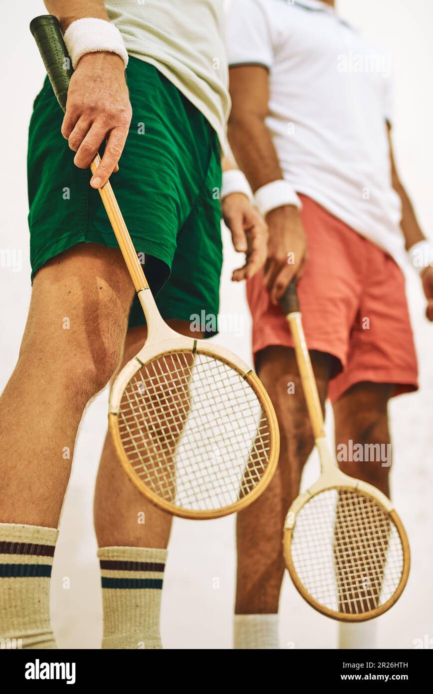 Get a grip on your game. two men holding their racquets at a squash ...