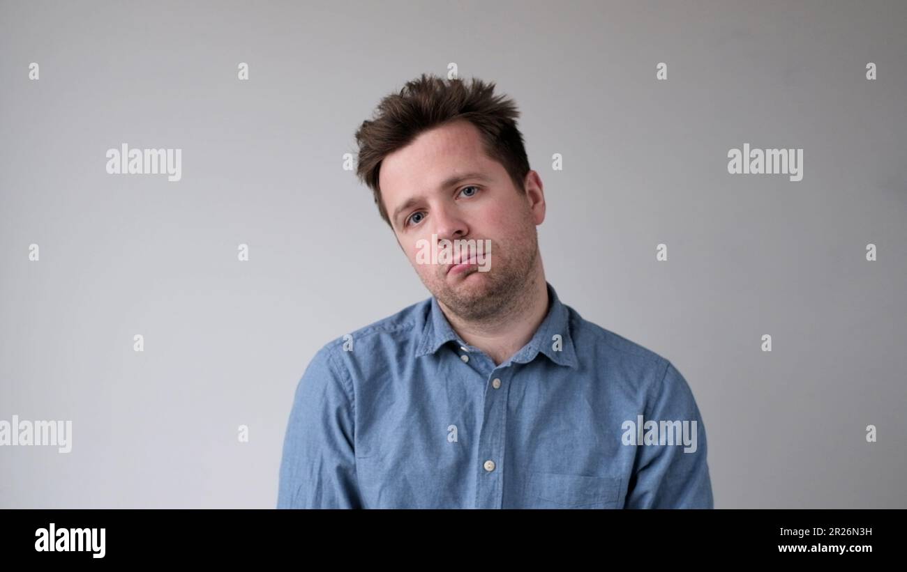 The angry European young man wearily looks. He is without strength and ...