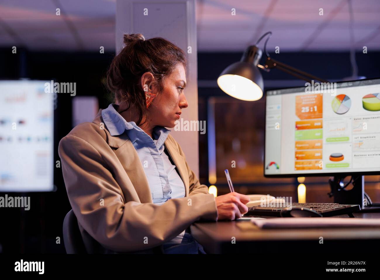 Corporate employee checking marketing graphs report Stock Photo - Alamy