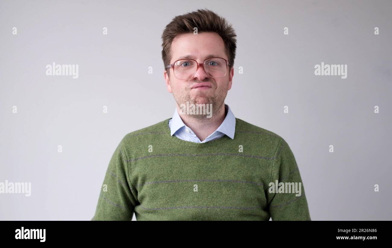 The angry European young man wearily looks. He is without strength and ...