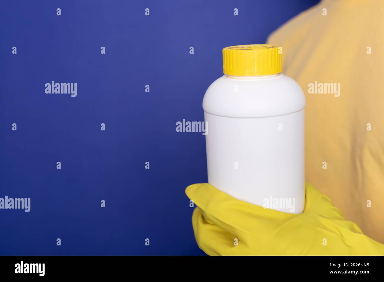 Woman Hand In Yellow Gloves Holds White Bottle With Pipe Cleaner ...
