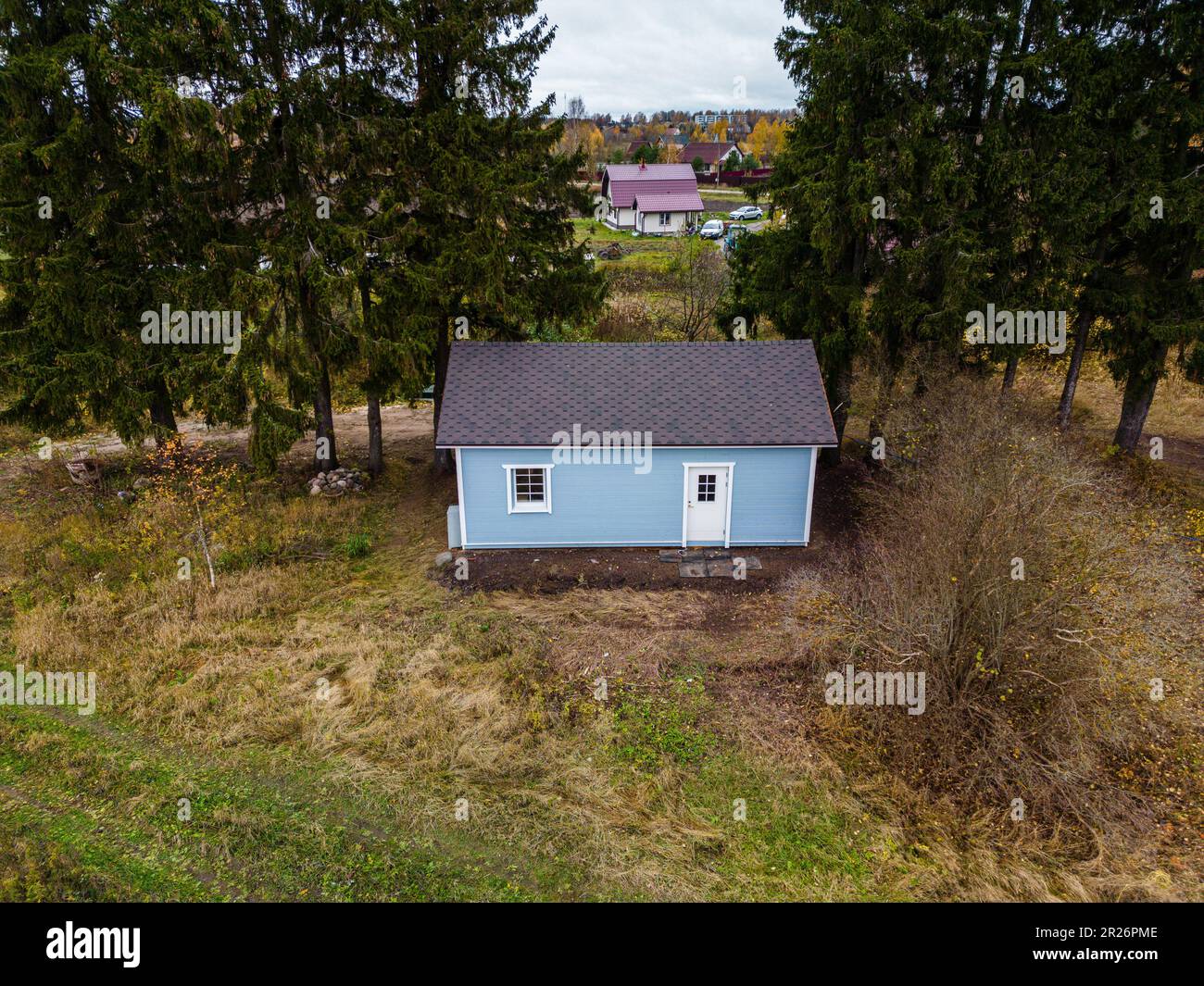 Small cozy blue house in the forest under tree Stock Photo - Alamy
