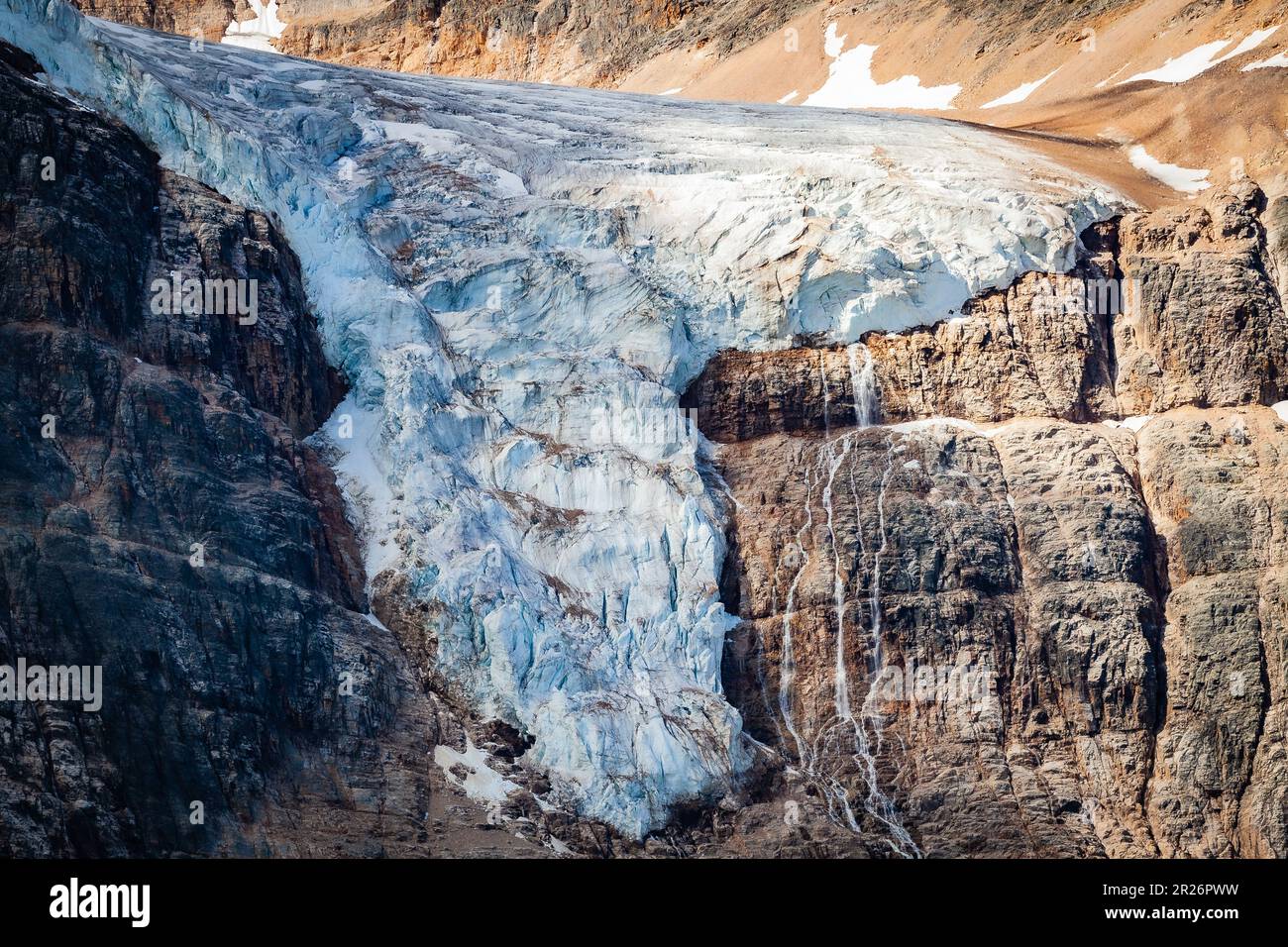 Rocky plateau with the glacier lying on the edge of the cliff. Small ...