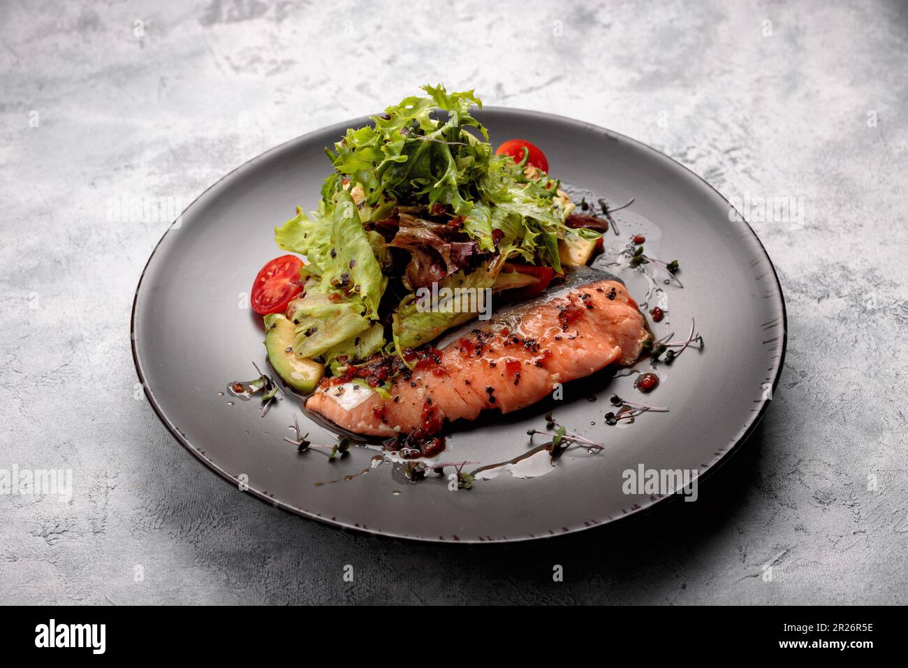 perfectly cooked salmon fillet with vegetables and a side of salad mix ...