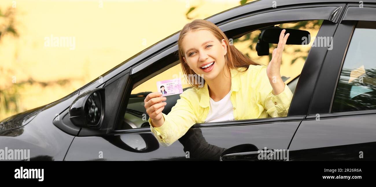 Happy young woman after successful passing of driving license test ...
