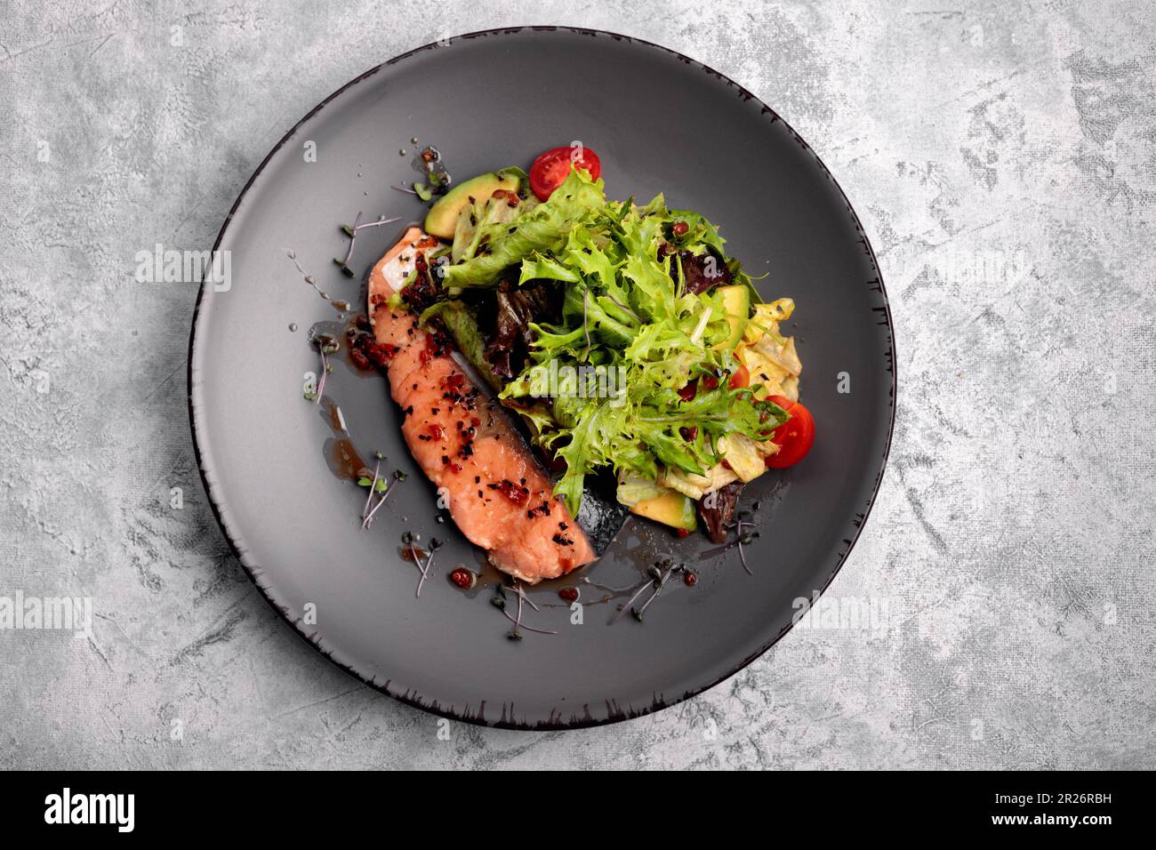 perfectly cooked salmon fillet with vegetables and a side of salad mix ...