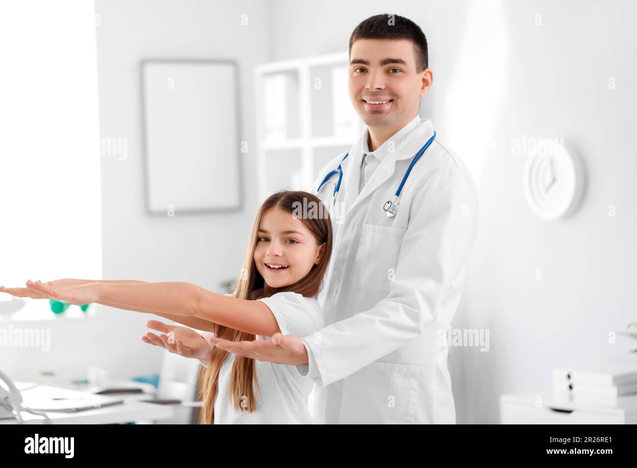 Doctor checking posture of little girl in clinic Stock Photo - Alamy