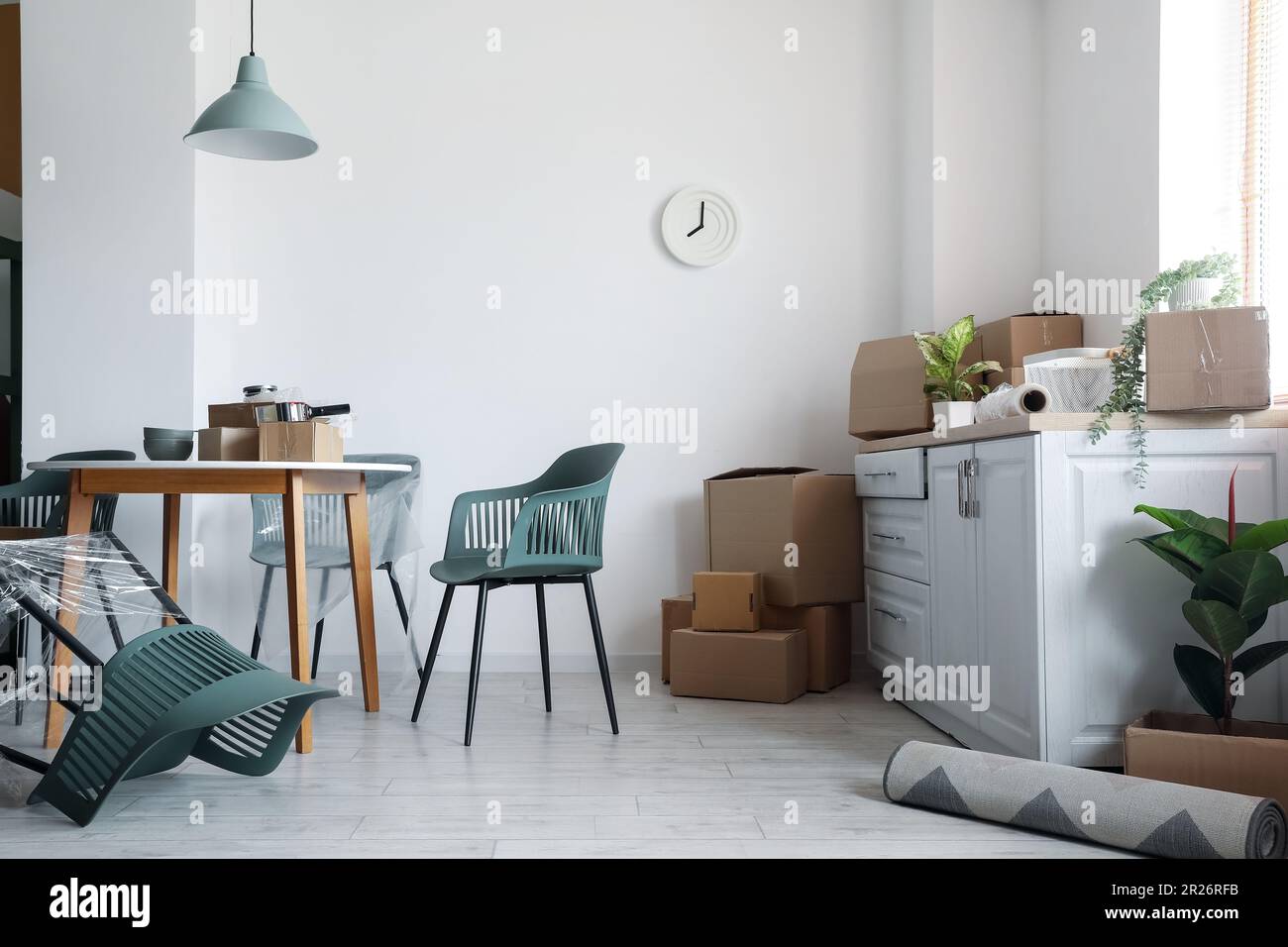 Dining table with cardboard boxes in kitchen on moving day Stock Photo ...