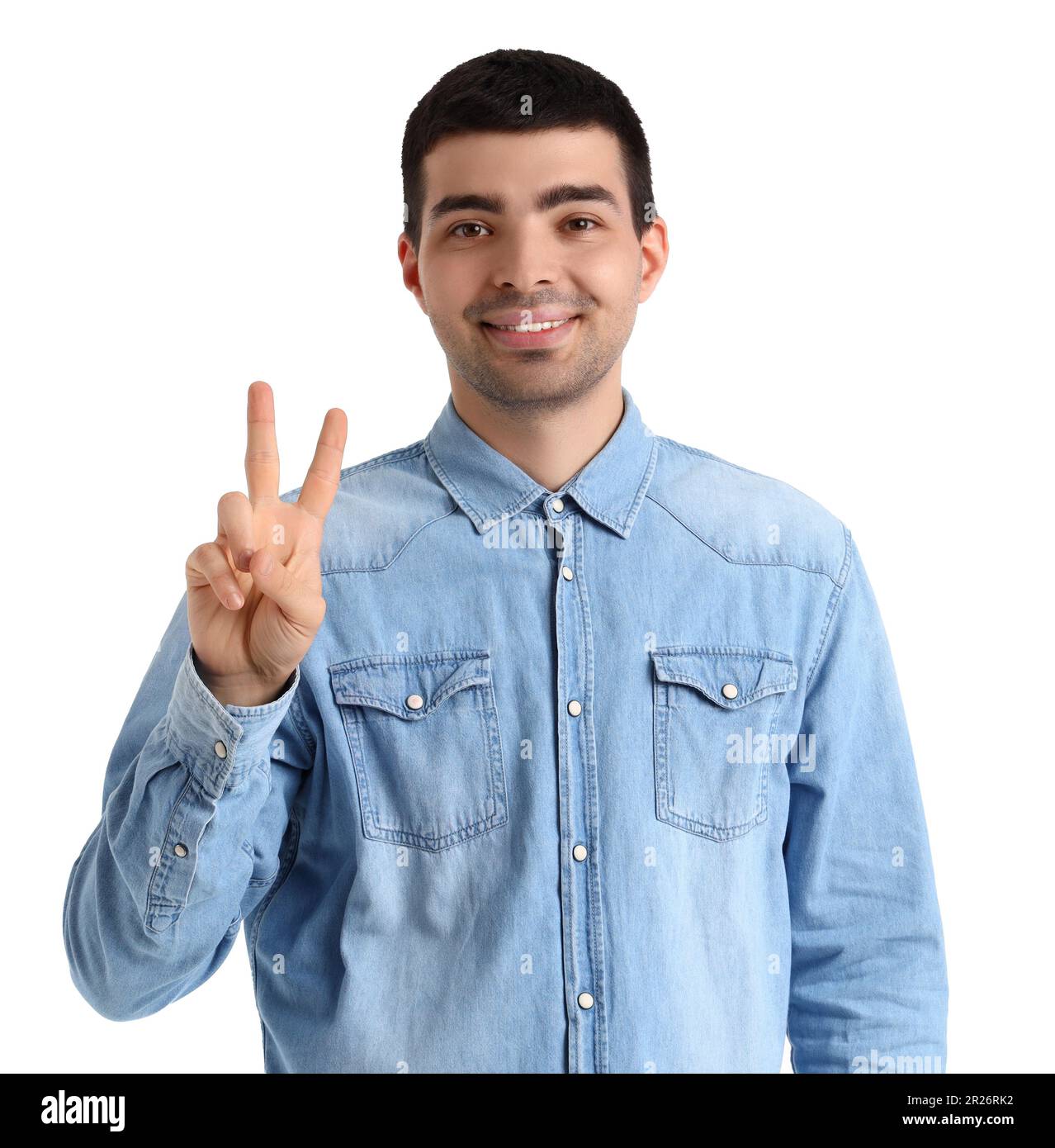 Young man showing two fingers on white background Stock Photo - Alamy