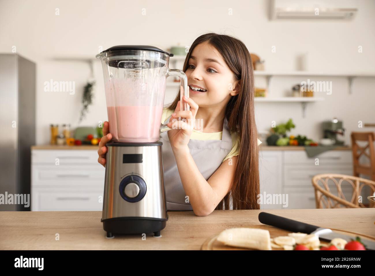 Little girl making smoothie with blender in kitchen Stock Photo - Alamy