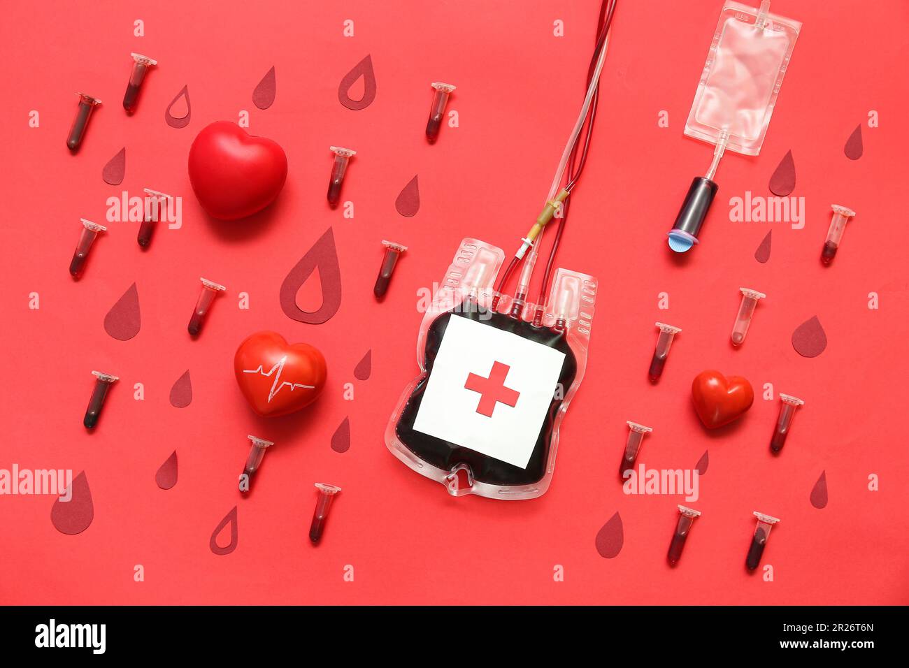 Blood pack with tubes, hearts and paper drops on red background. World ...