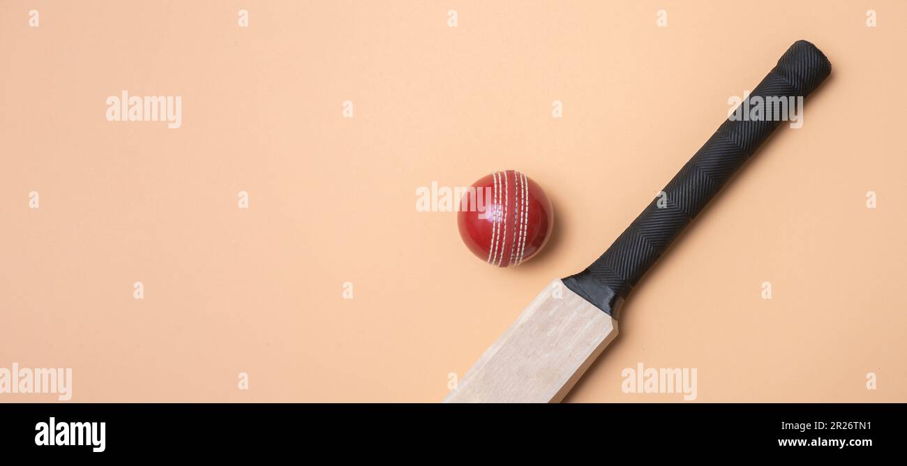 Cricket bat and red balls on beige background. Horizontal sport theme ...