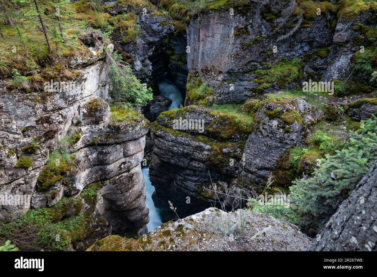 A glimpse of the waterfall in the middle of the rocks, Rift in the ...