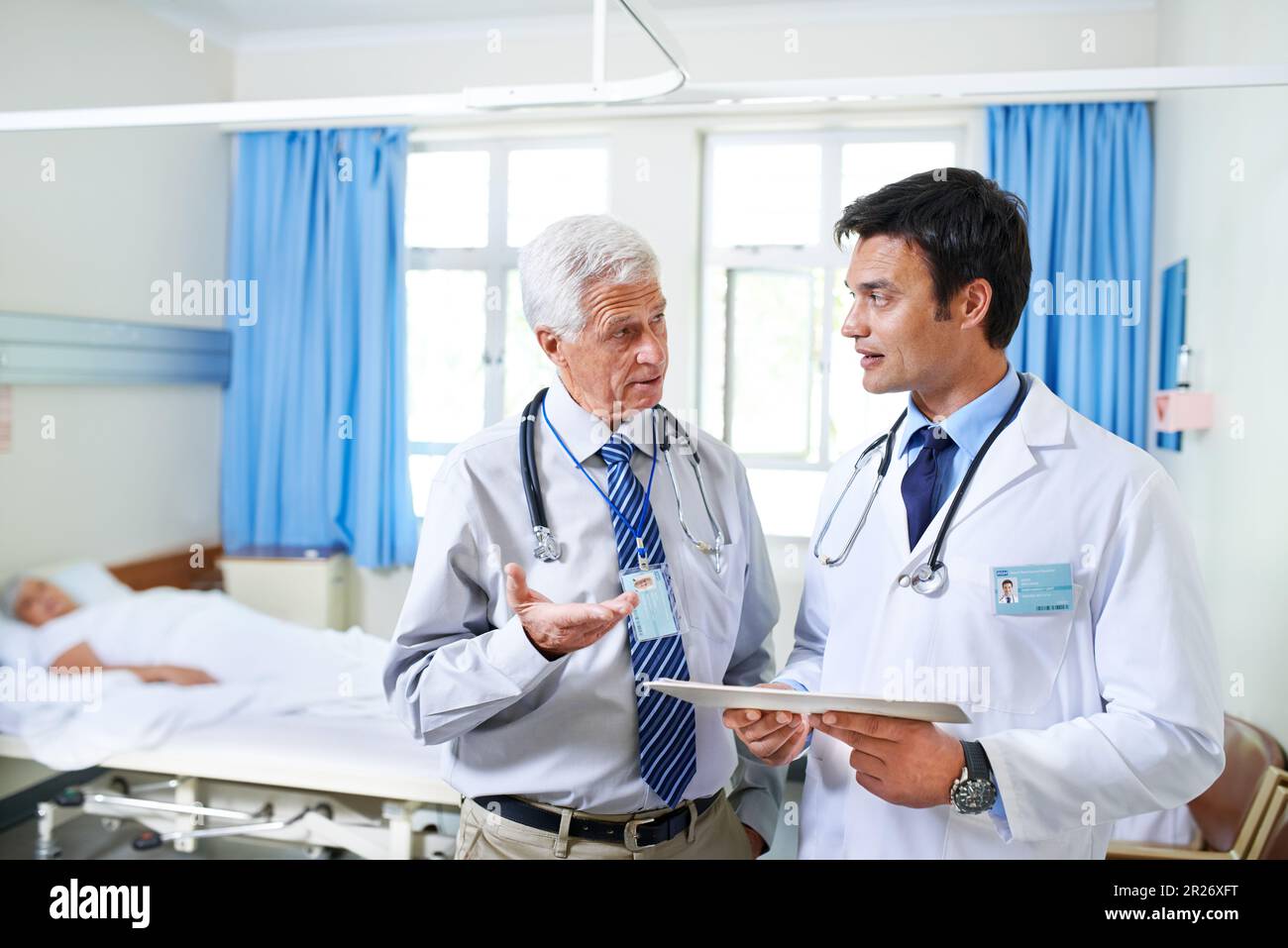Getting another point of view. two doctors discussing a case file with ...
