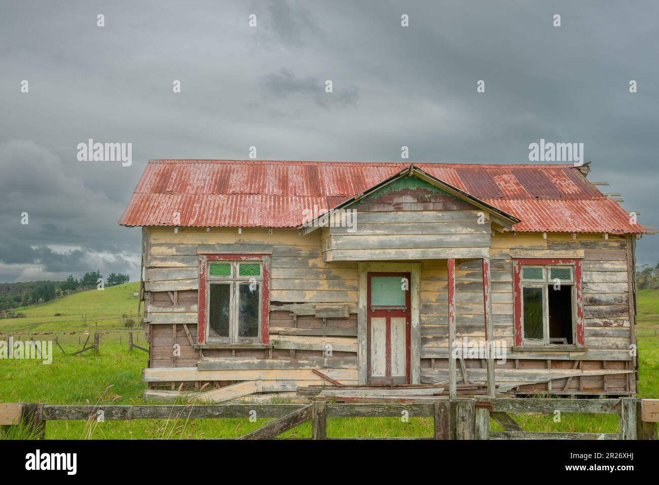 Remains of old farm house under overcast moody sky on rural road in New ...