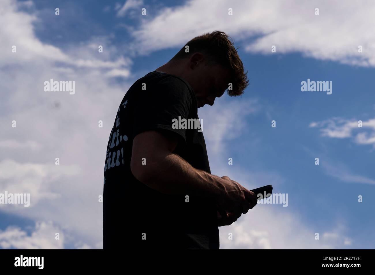 Adam Botkin, a football TikTok influencer, uses his phone while ...