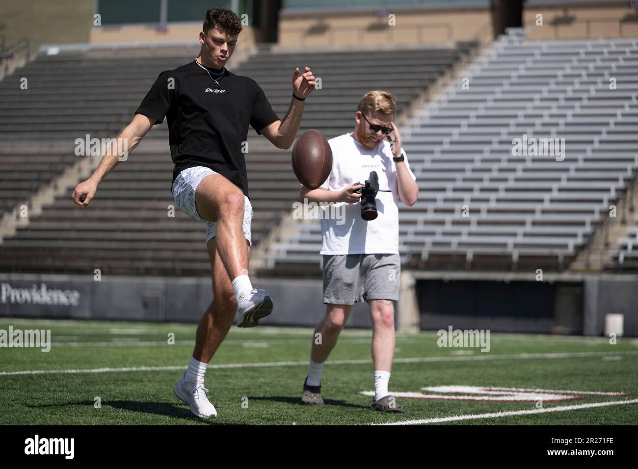 Adam Botkin, a football TikTok influencer, punts the ball while ...