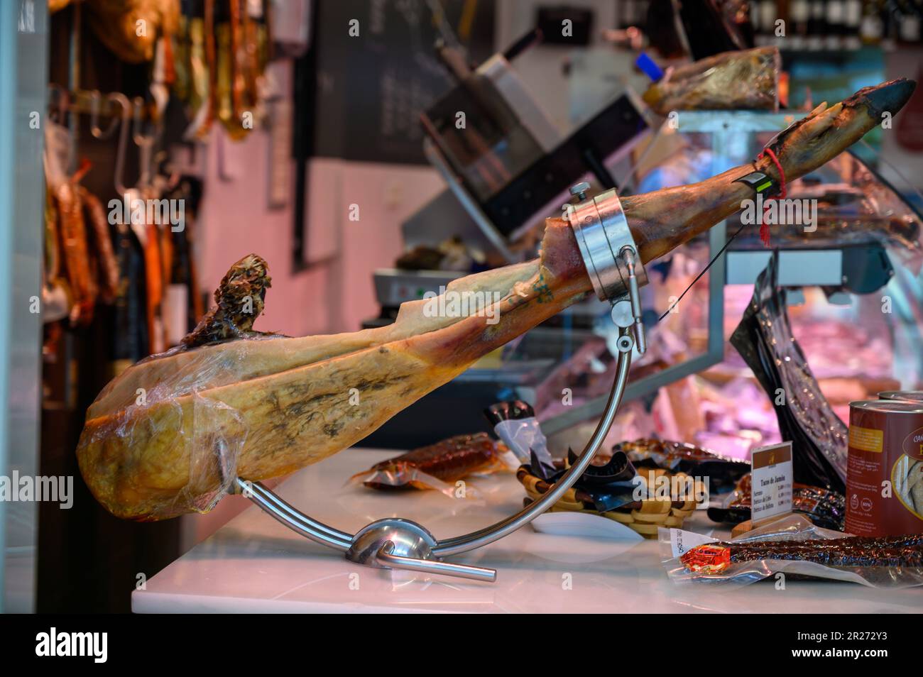 Leg of pork serrano Iberian cured jamon on stand in Spanish butcher's ...