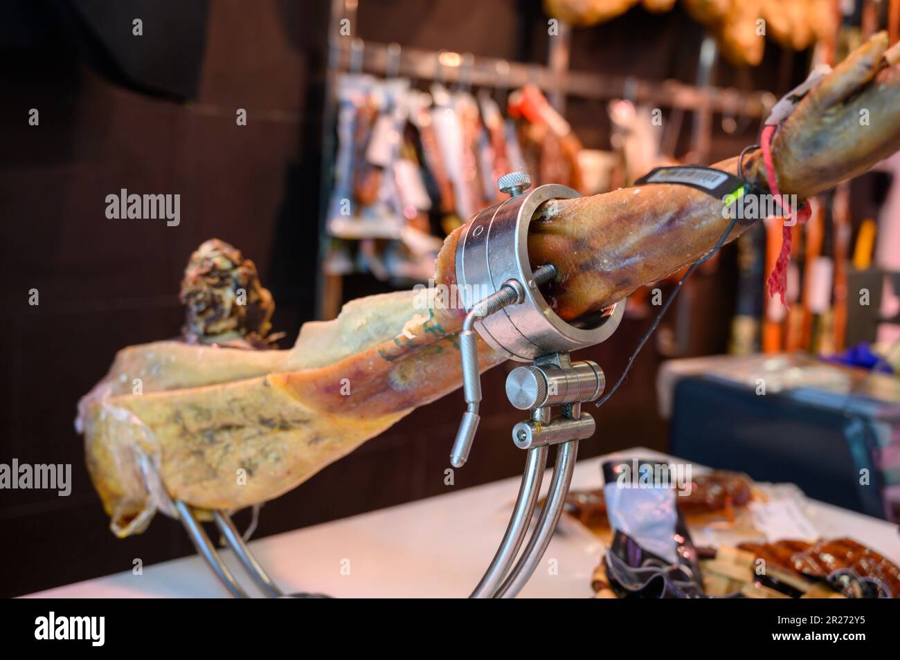 Leg of pork serrano Iberian cured jamon on stand in Spanish butcher's ...