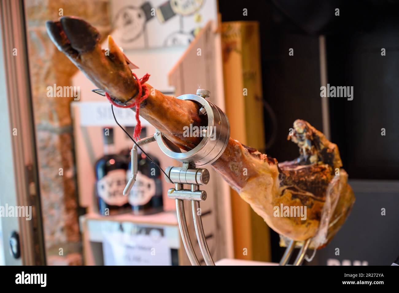 Leg of pork serrano Iberian cured jamon on stand in Spanish butcher's ...