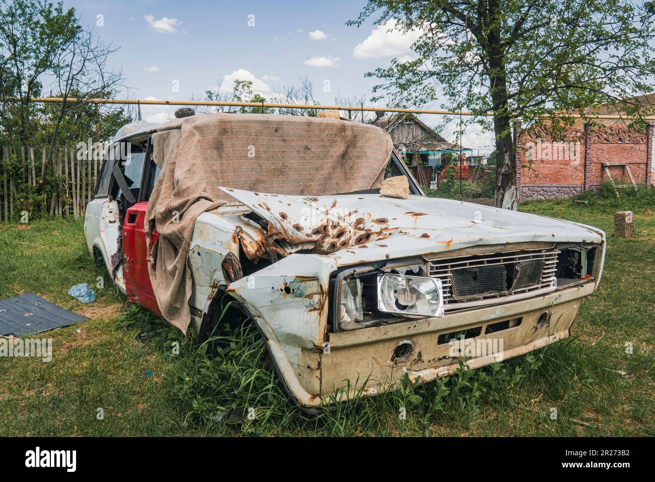 A car in the countryside, damaged by artillery fire. War in Ukraine ...