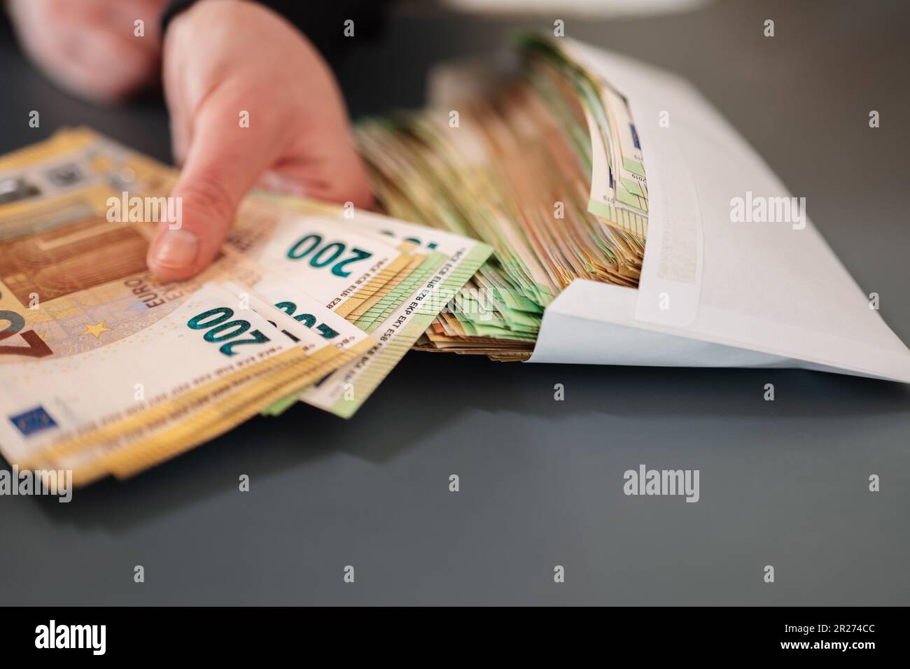 Envelope with money . hand sorting out Euro bills in an envelope on a ...